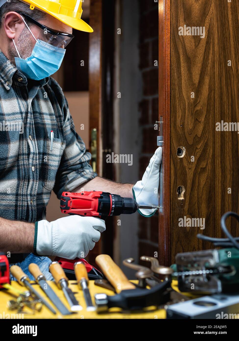 Carpenter at work protects the face with the surgical mask. Covid-19 ...