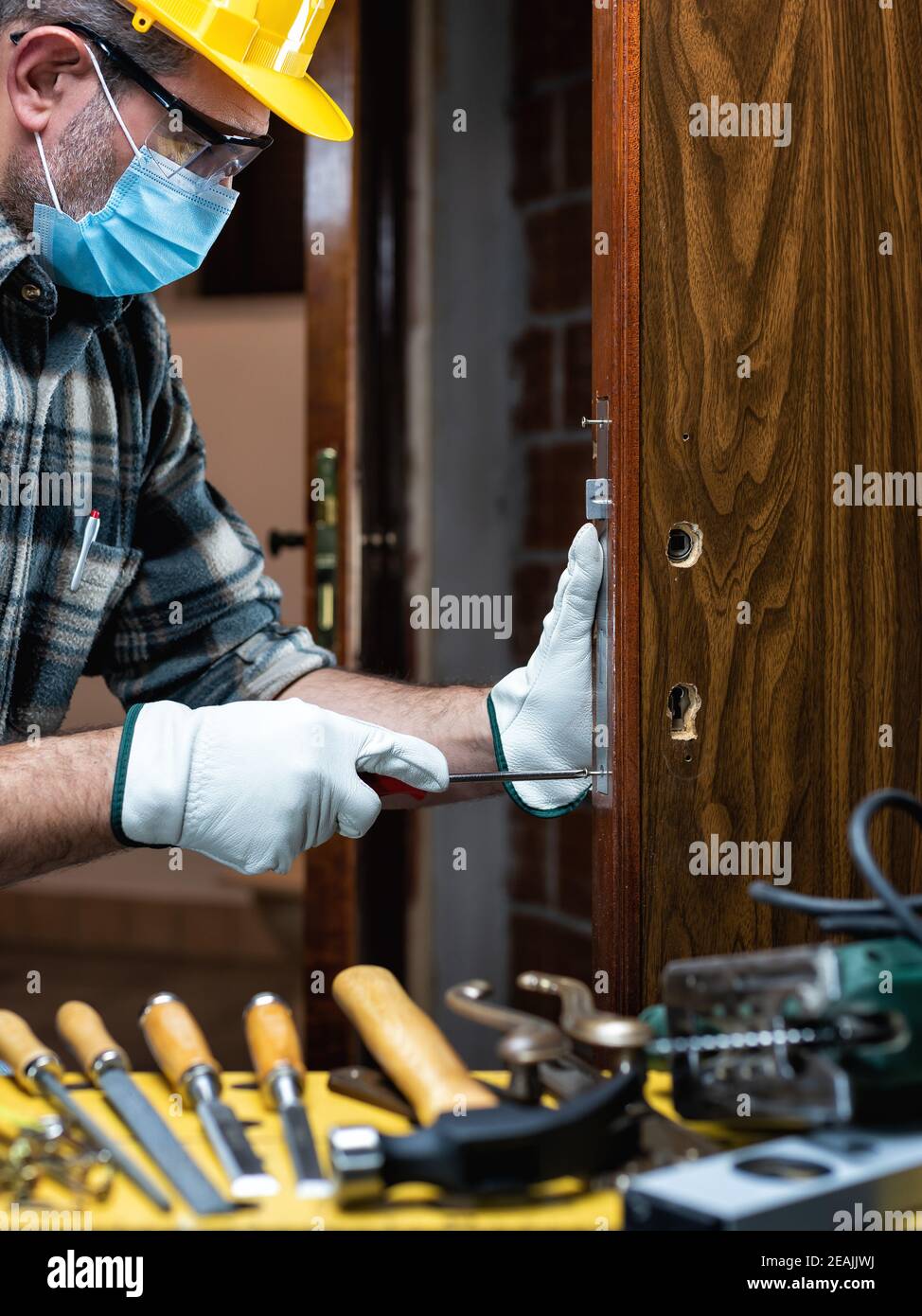 Carpenter at work protects the face with the surgical mask. Covid-19 ...