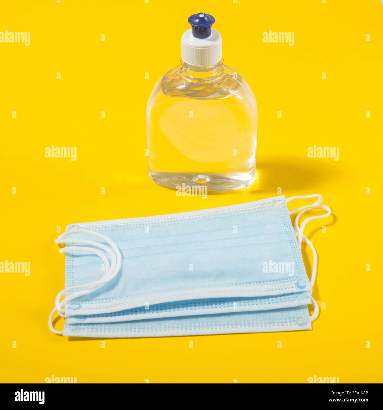 Alcohol gel hand sanitizer and disposable hygienic mask Stock Photo - Alamy