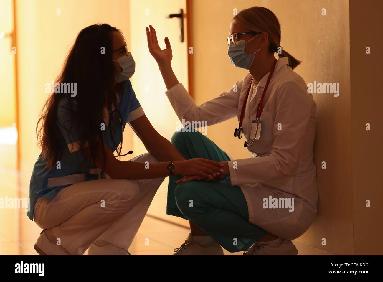 Two frustrated doctors are sitting in hospital corridor Stock Photo - Alamy