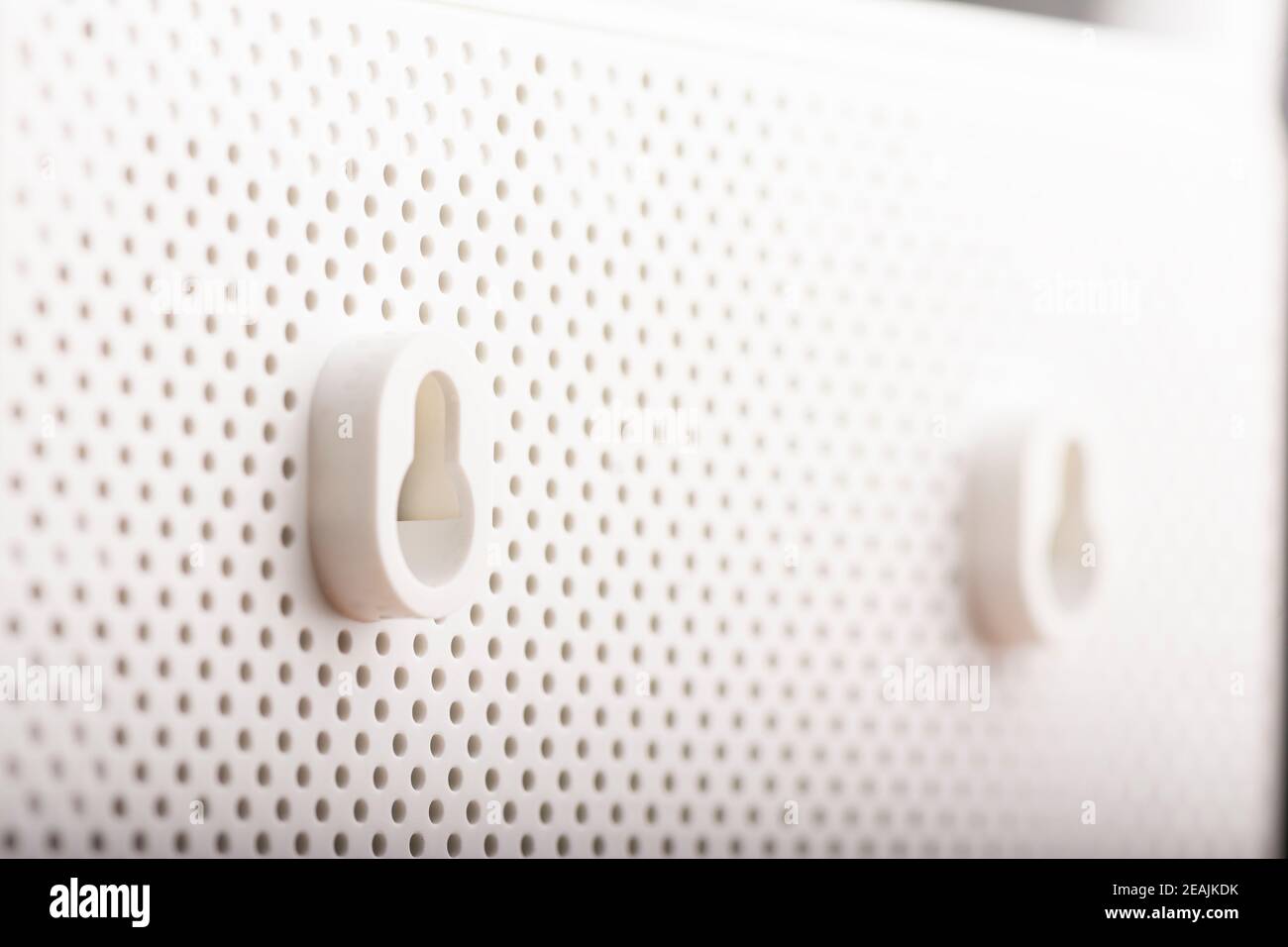 Modern white wireless internet router backside with wall mount place ...