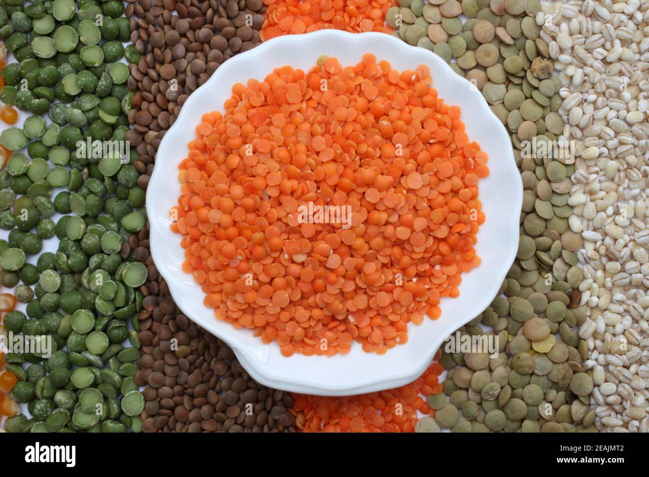 Ceramic plate with lentils over seeds and grains background Stock Photo ...