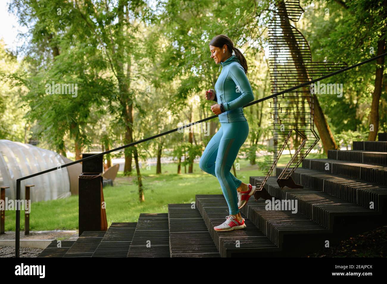 Morning workout in park, woman jogging by steps Stock Photo - Alamy