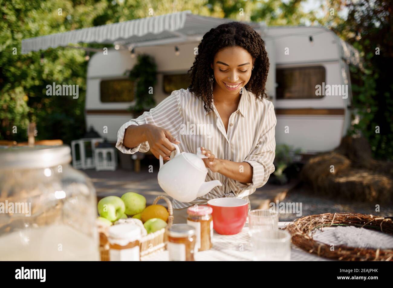 Female person cooking breakfast near rv, camping Stock Photo - Alamy