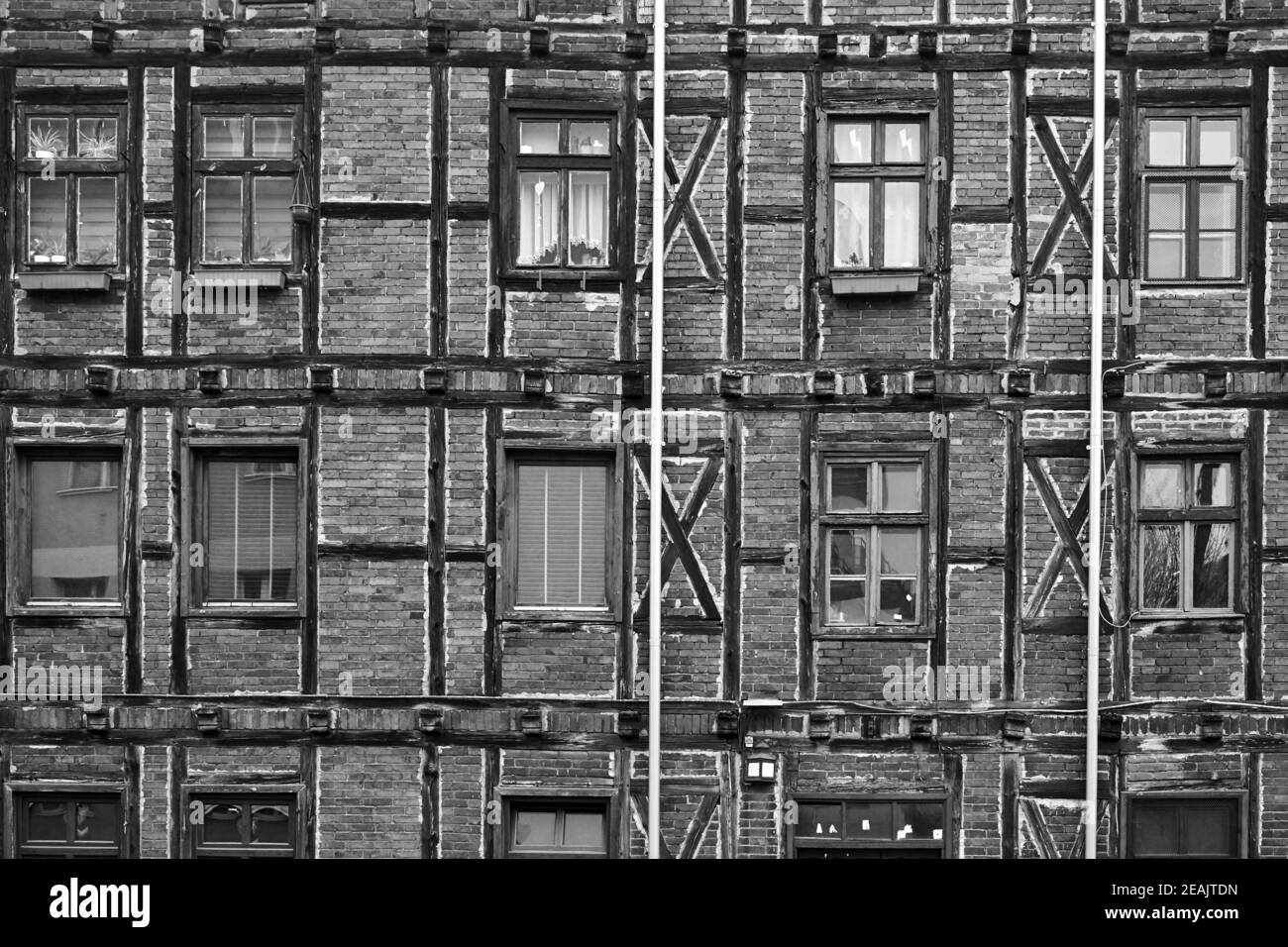 Windows in the frame wall of a historic house in Poznan, monochrome ...