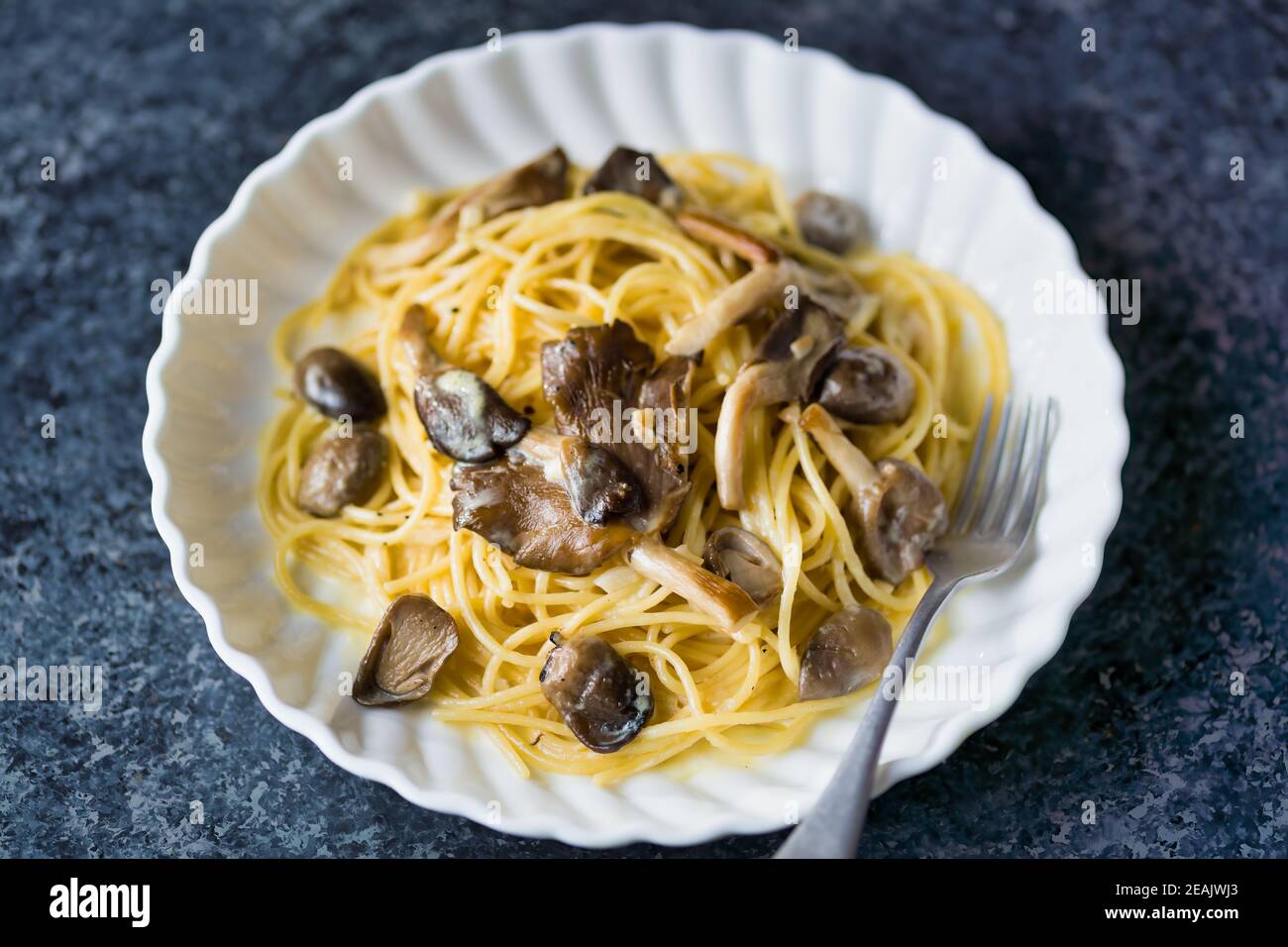 rustic italian spaghetti pasta in mushroom cream sauce Stock Photo - Alamy
