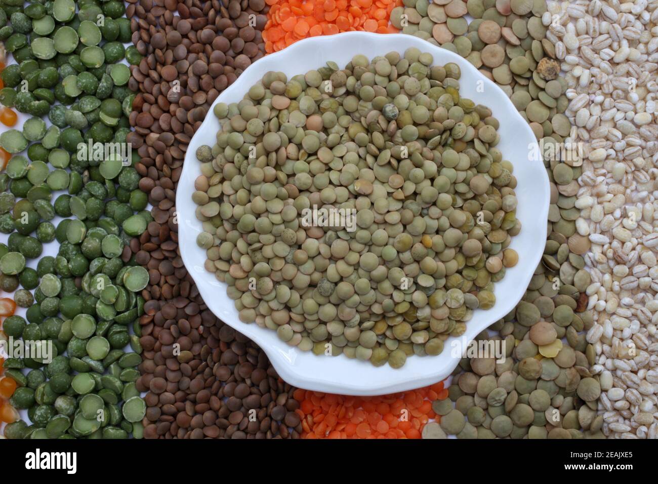 Ceramic plate with lentils over seeds and grains background Stock Photo ...