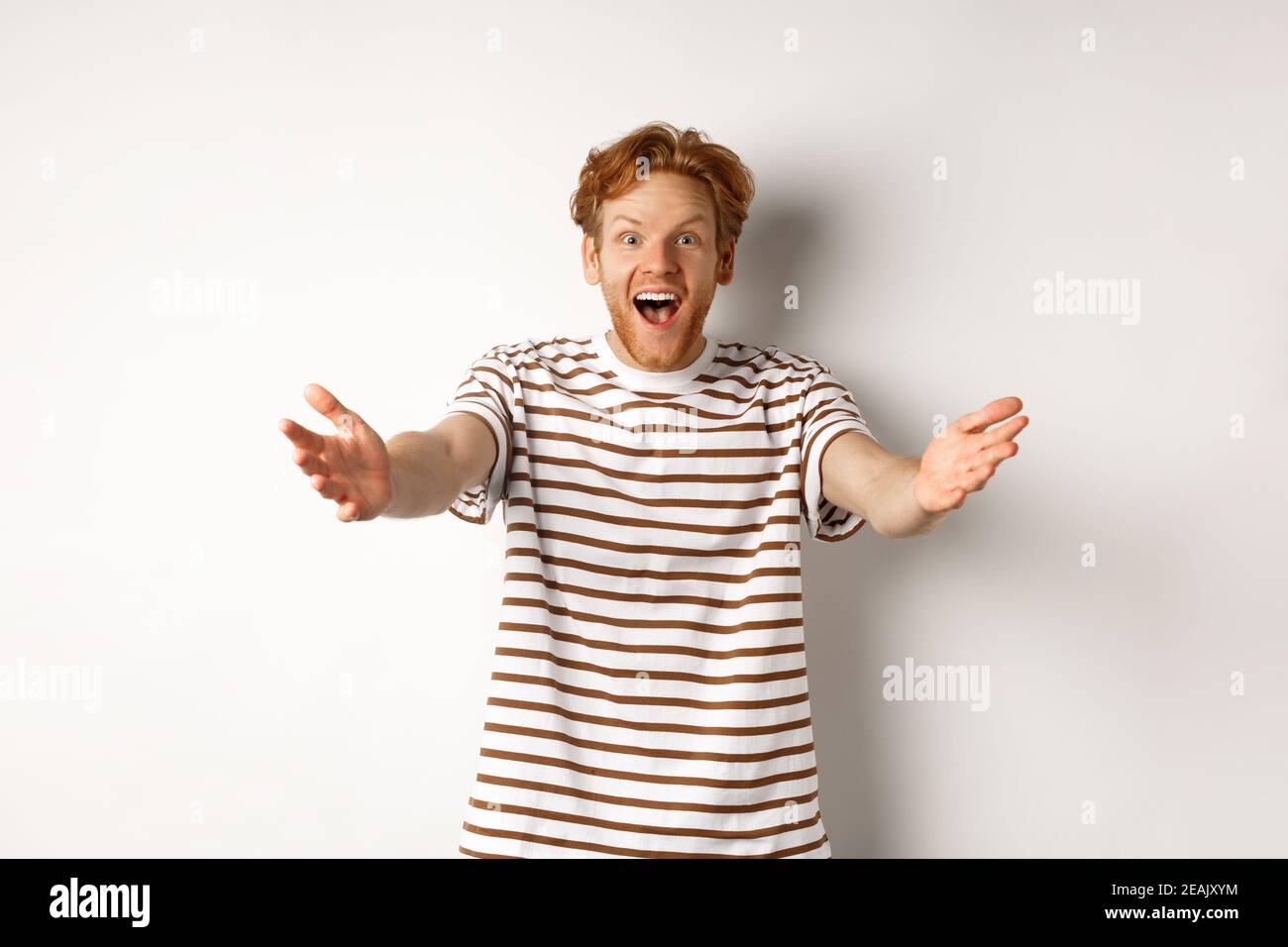 Cheerful man with red curly hair reaching hands forward, stretch out ...