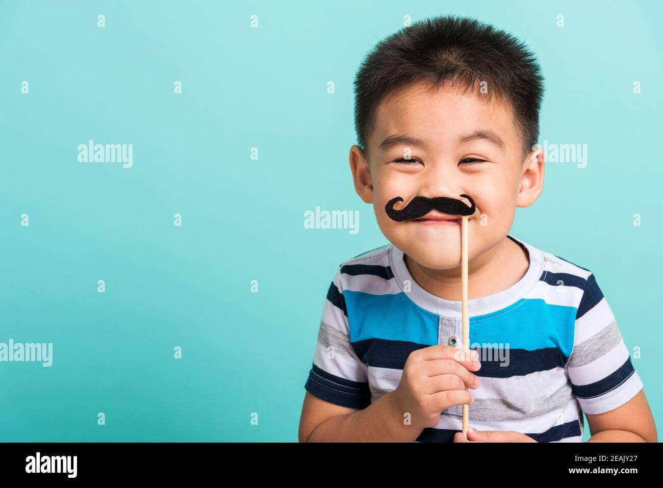 Funny happy hipster kid holding black mustache Stock Photo - Alamy