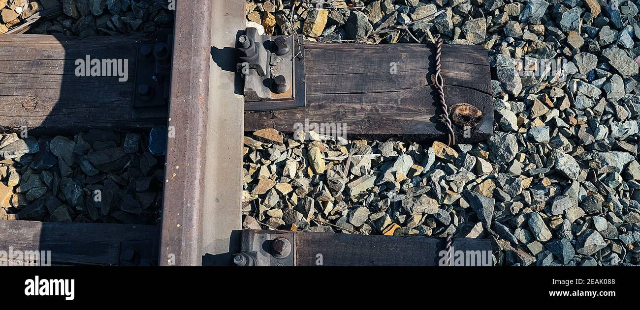 Single rail as part of a railway. Wooden sleepers and gravel are also ...