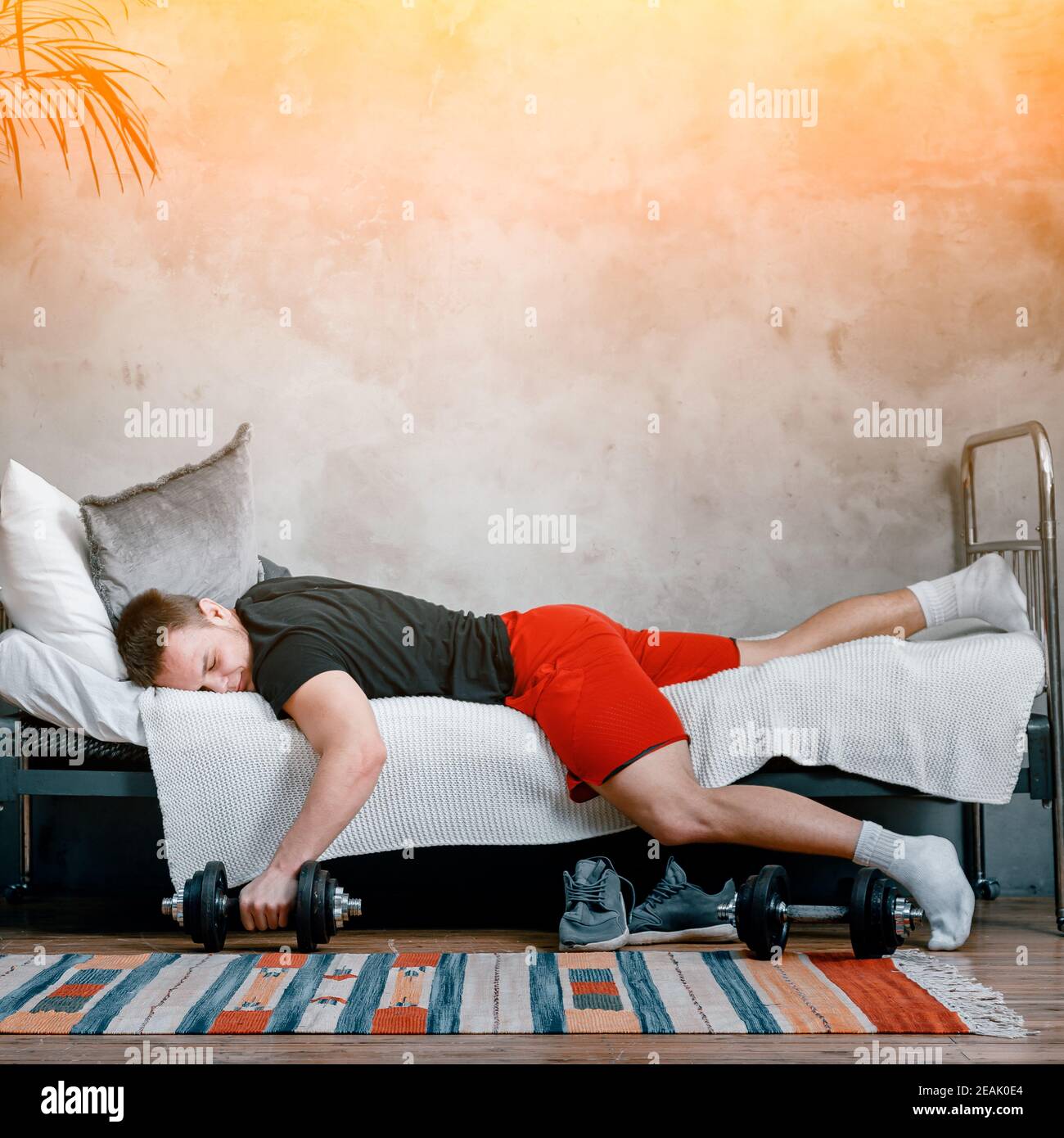 Close-up of a young man in a sports uniform is resting, sleeping on a ...