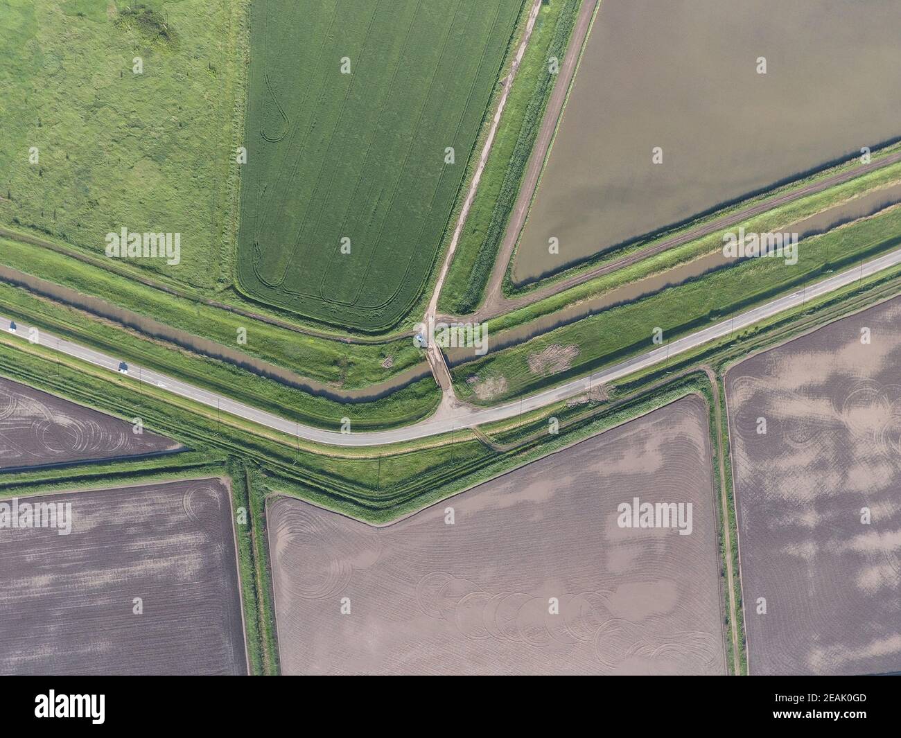Adjoining the dirt road to the road with asphalt Stock Photo - Alamy