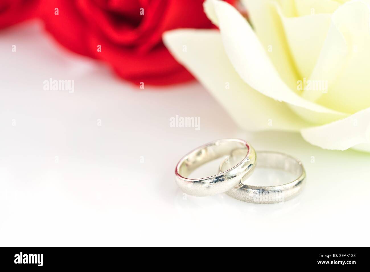 Red rose and wedding ring on white Stock Photo - Alamy