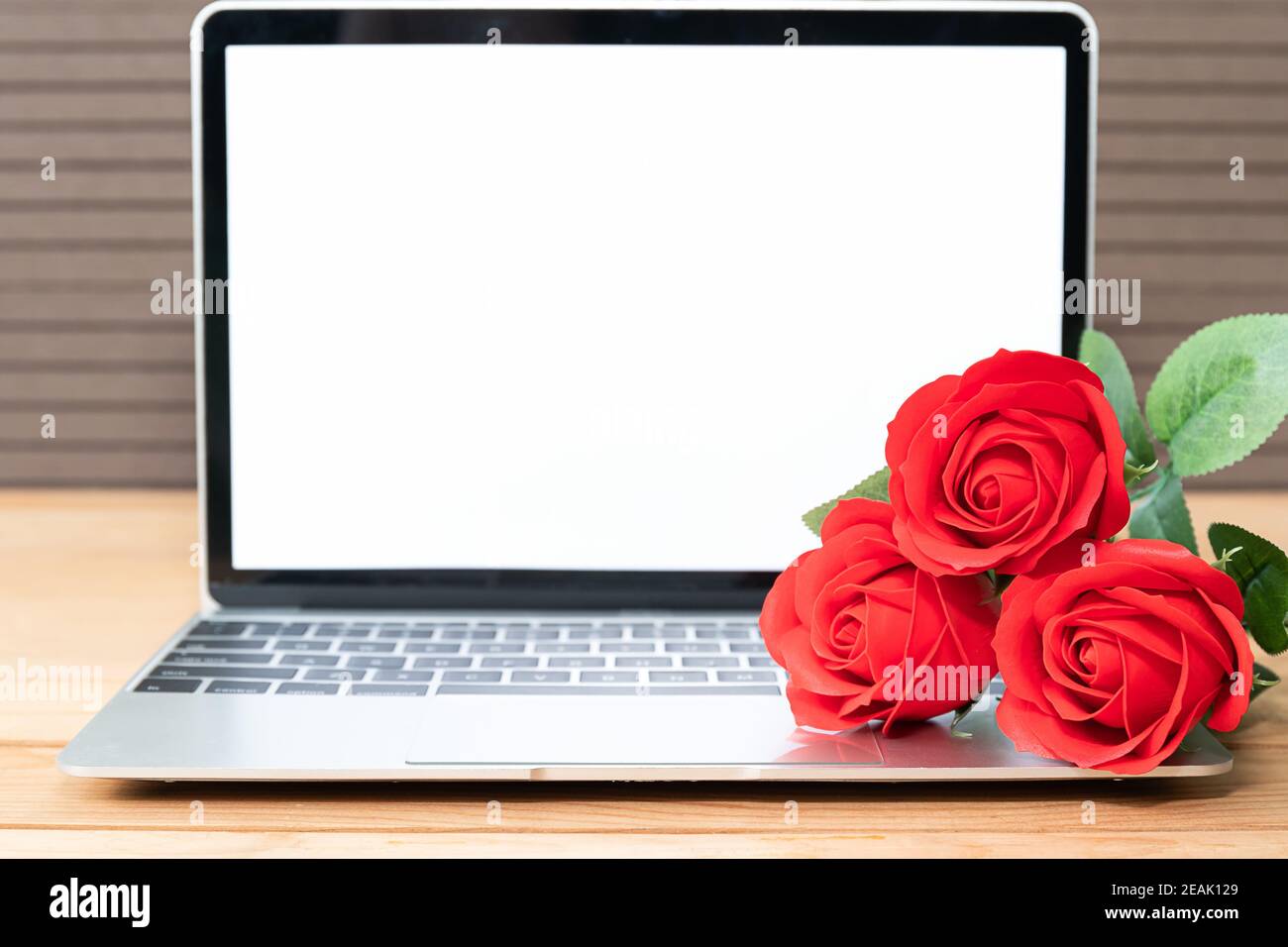 Red rose and laptop mockup on wood Stock Photo - Alamy