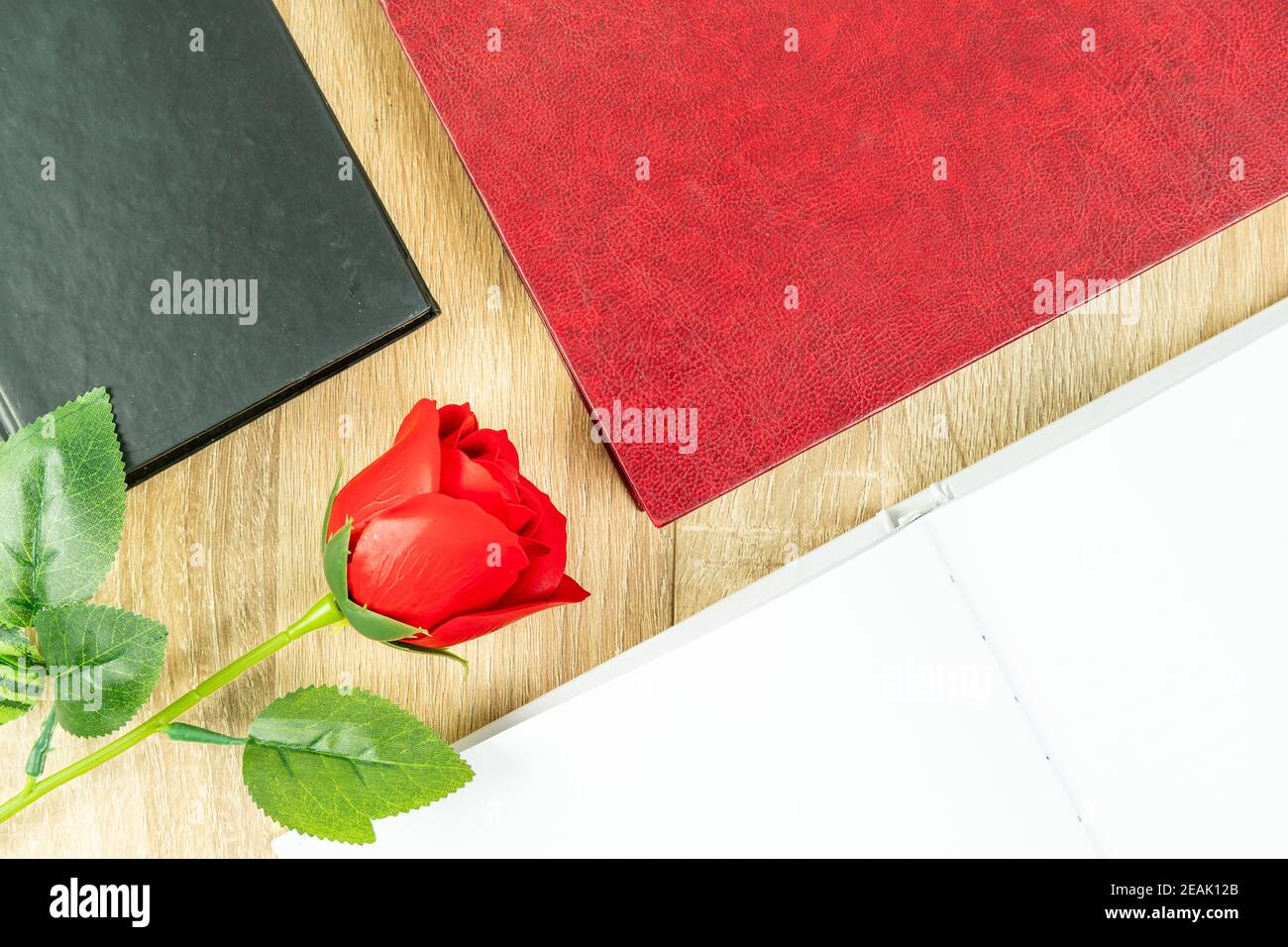 Red roses and empty blank notebook diary and eye glasses with hardcover ...