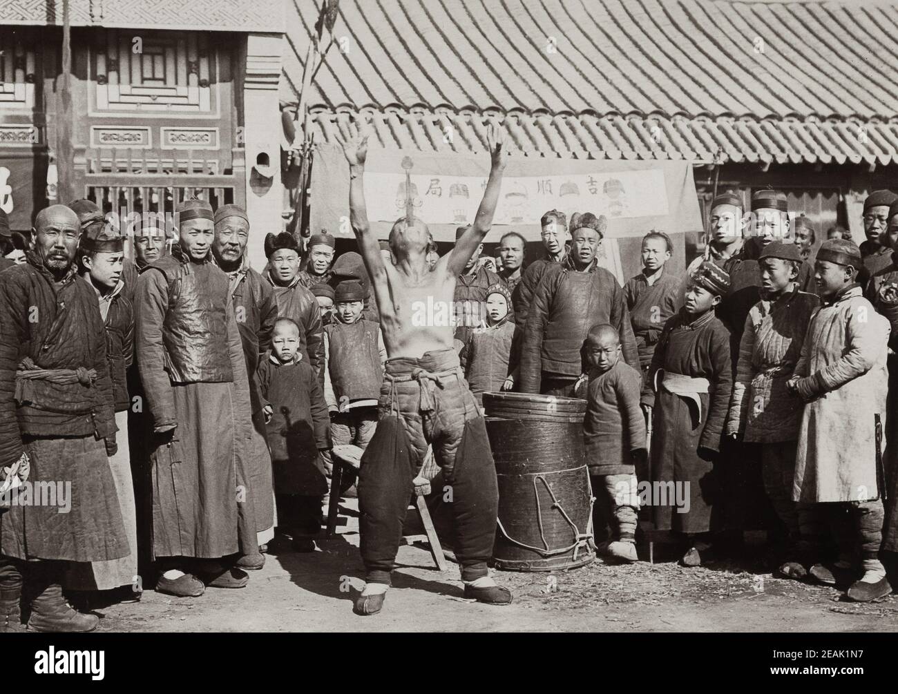 Early 20th century photograph: Chinese man swallowing a sword, street ...