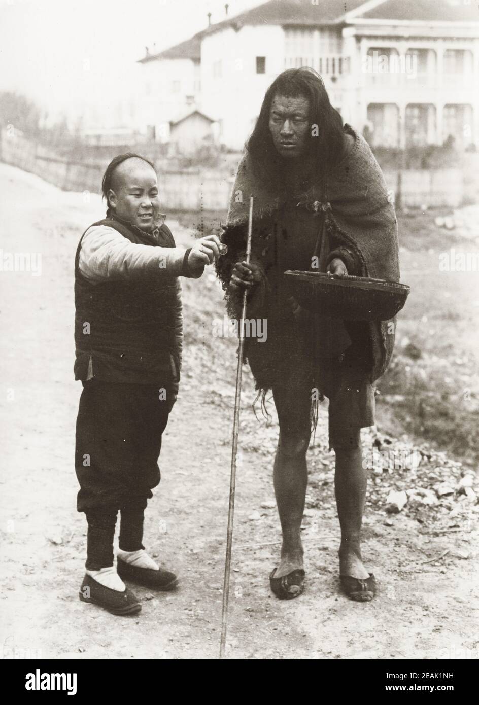 Early 20th century photograph: Chinese beggar with bowl and stick ...