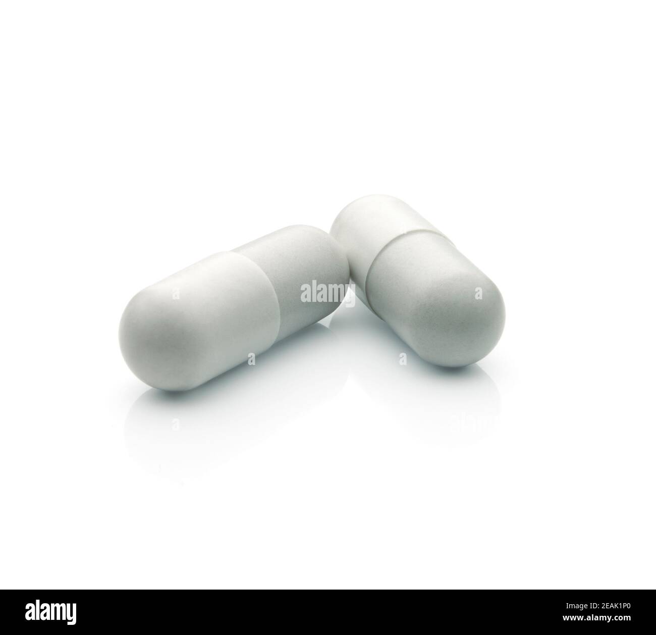 Two white pills tablets Cut Out Stock Images & Pictures - Alamy