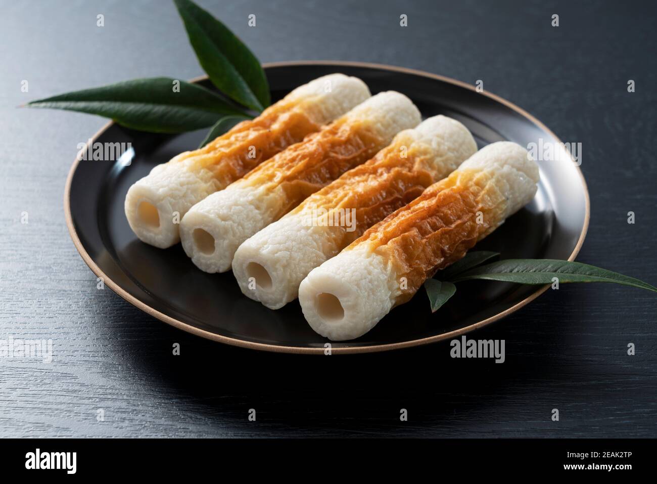 Japanese chikuwa placed on a black background Stock Photo - Alamy