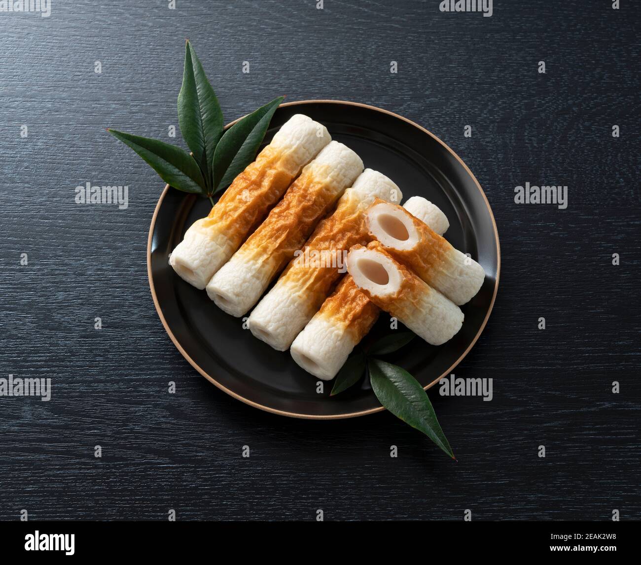 Japanese chikuwa placed on a black background Stock Photo - Alamy
