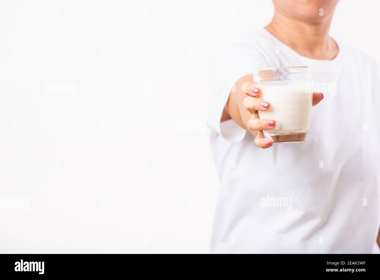 Woman use hands hold drink white milk from a glass Stock Photo - Alamy