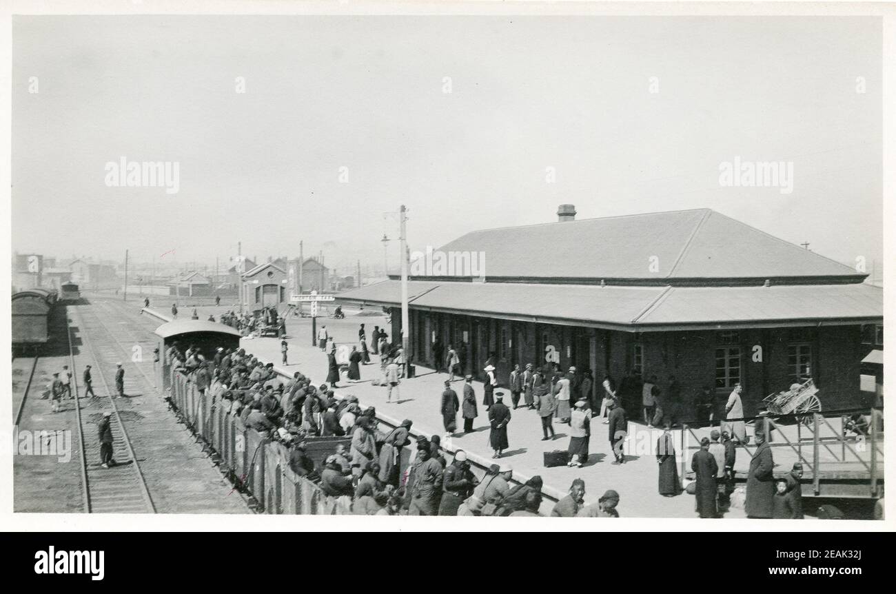 Early 20th century photograph: Railway station, passenger in open train ...