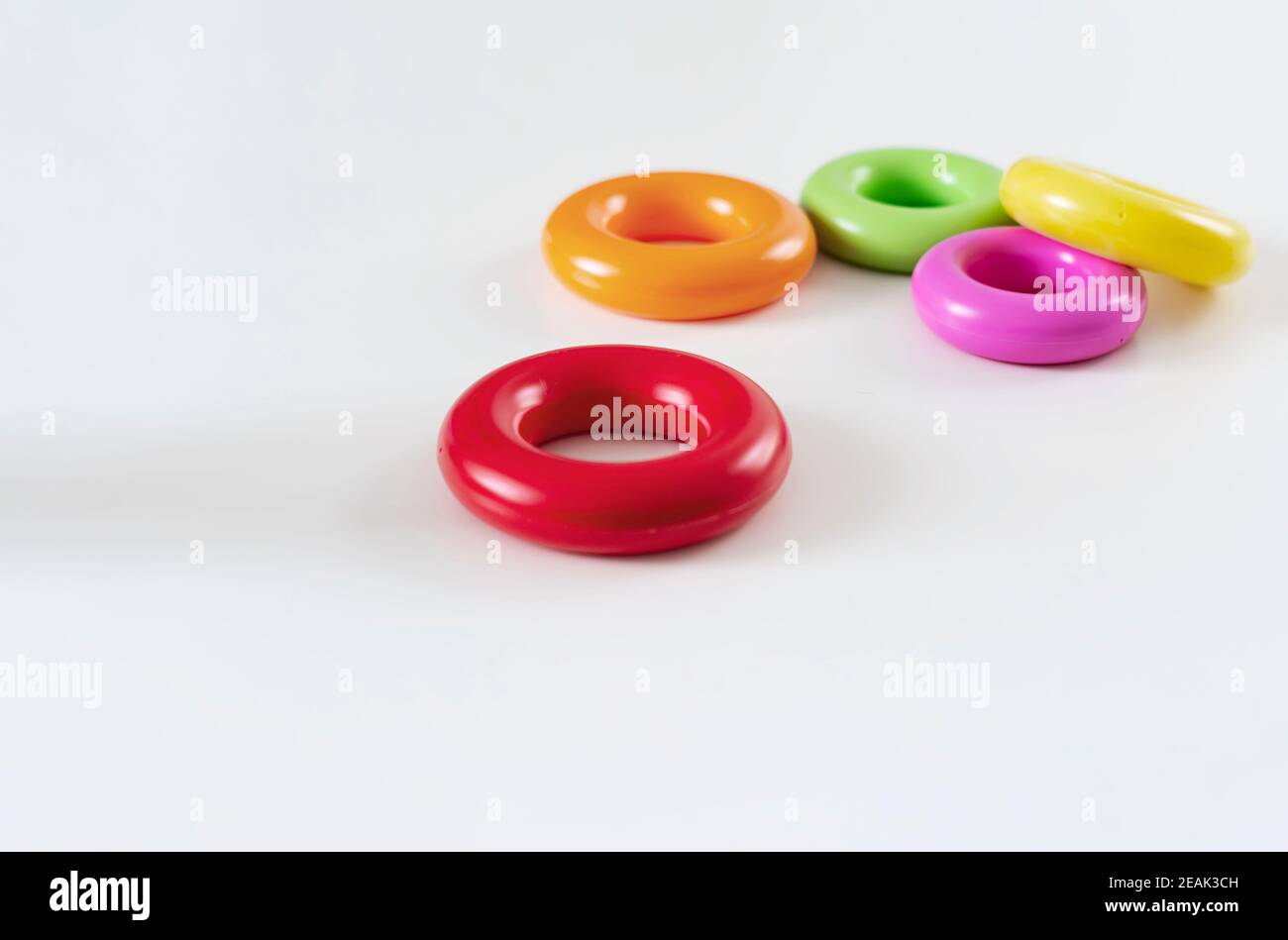 a group of of five colorful plastic rings isolated on a white ...