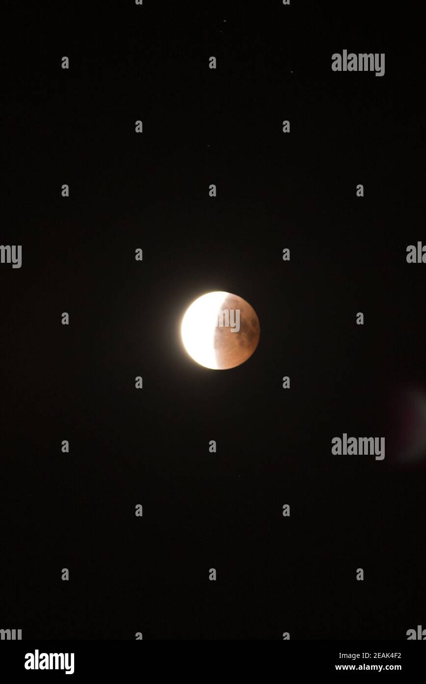 Lunar eclipse in the black night sky Stock Photo - Alamy
