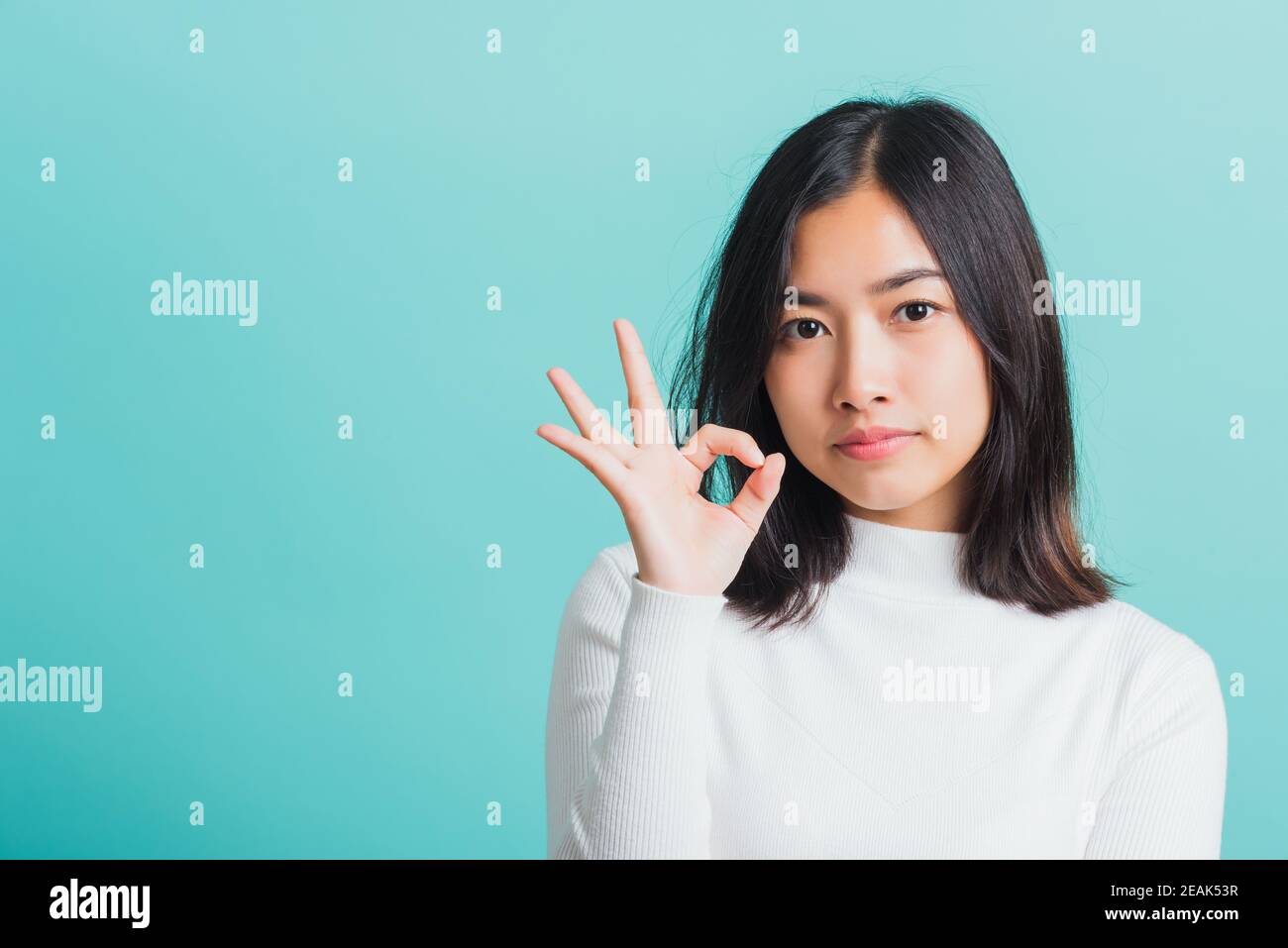 woman smiling and showing hand the OK sign Stock Photo - Alamy
