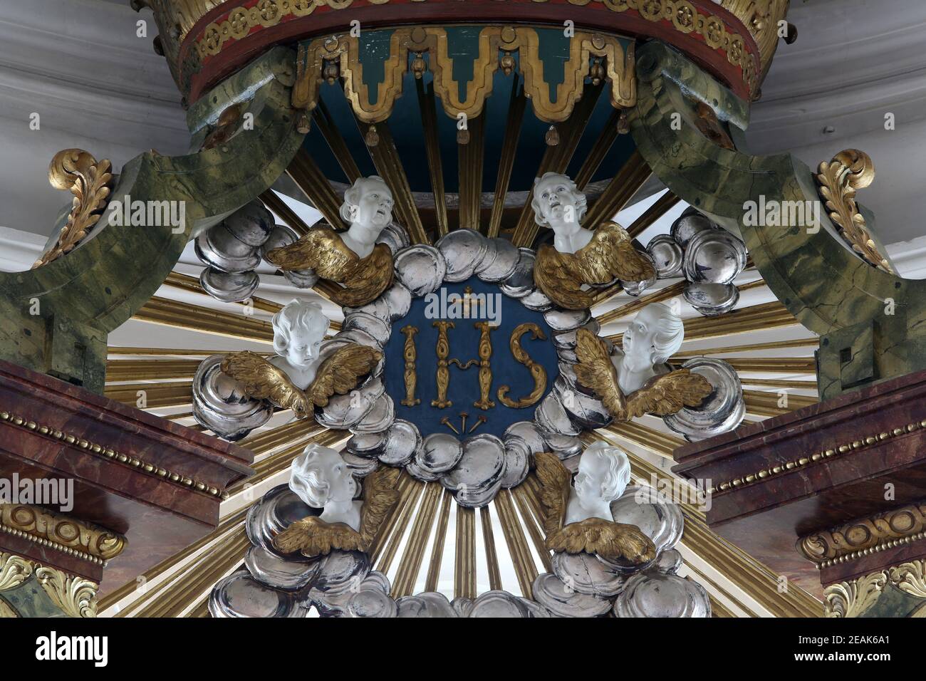 IHS sign (Christogram) above church altar, Basilica of St. Vitus in ...