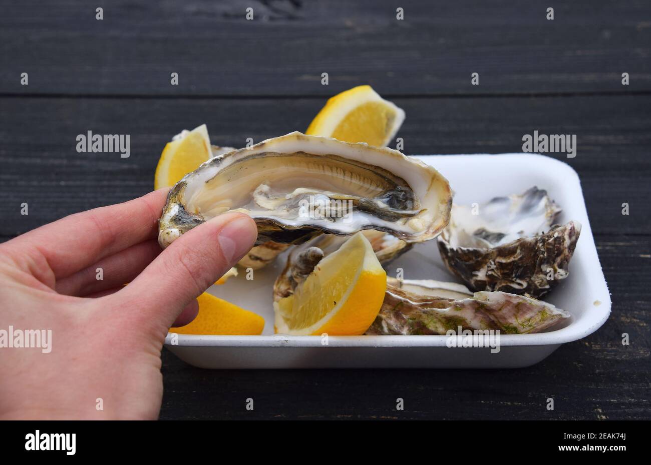 Woman eating oysters hi-res stock photography and images - Alamy