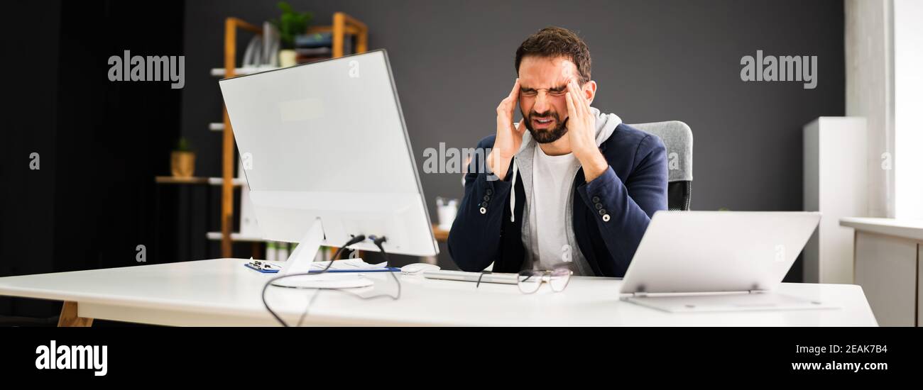 Man With Migraine From Computer Work. Bored Stock Photo - Alamy
