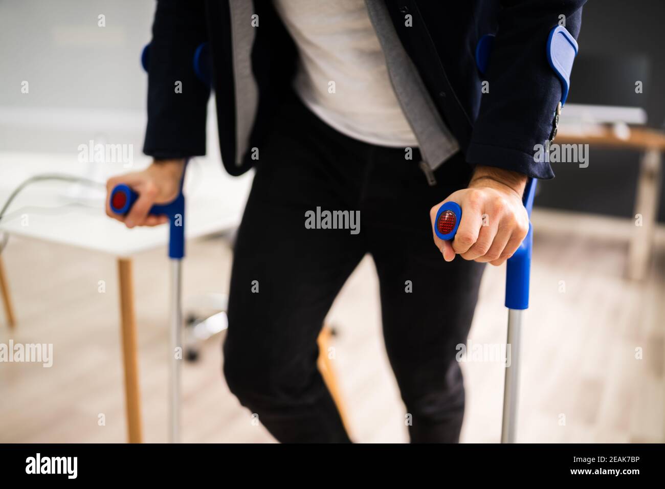 Disabled Man Standing With Crutches Stock Photo - Alamy