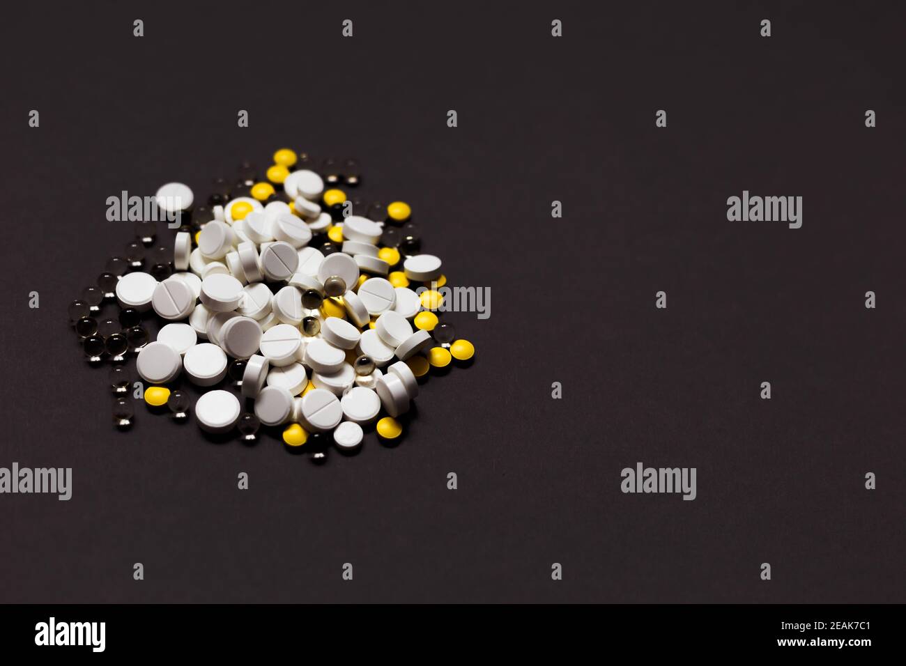 Medicines spilling out on dark gray background. Top view, flat lay ...