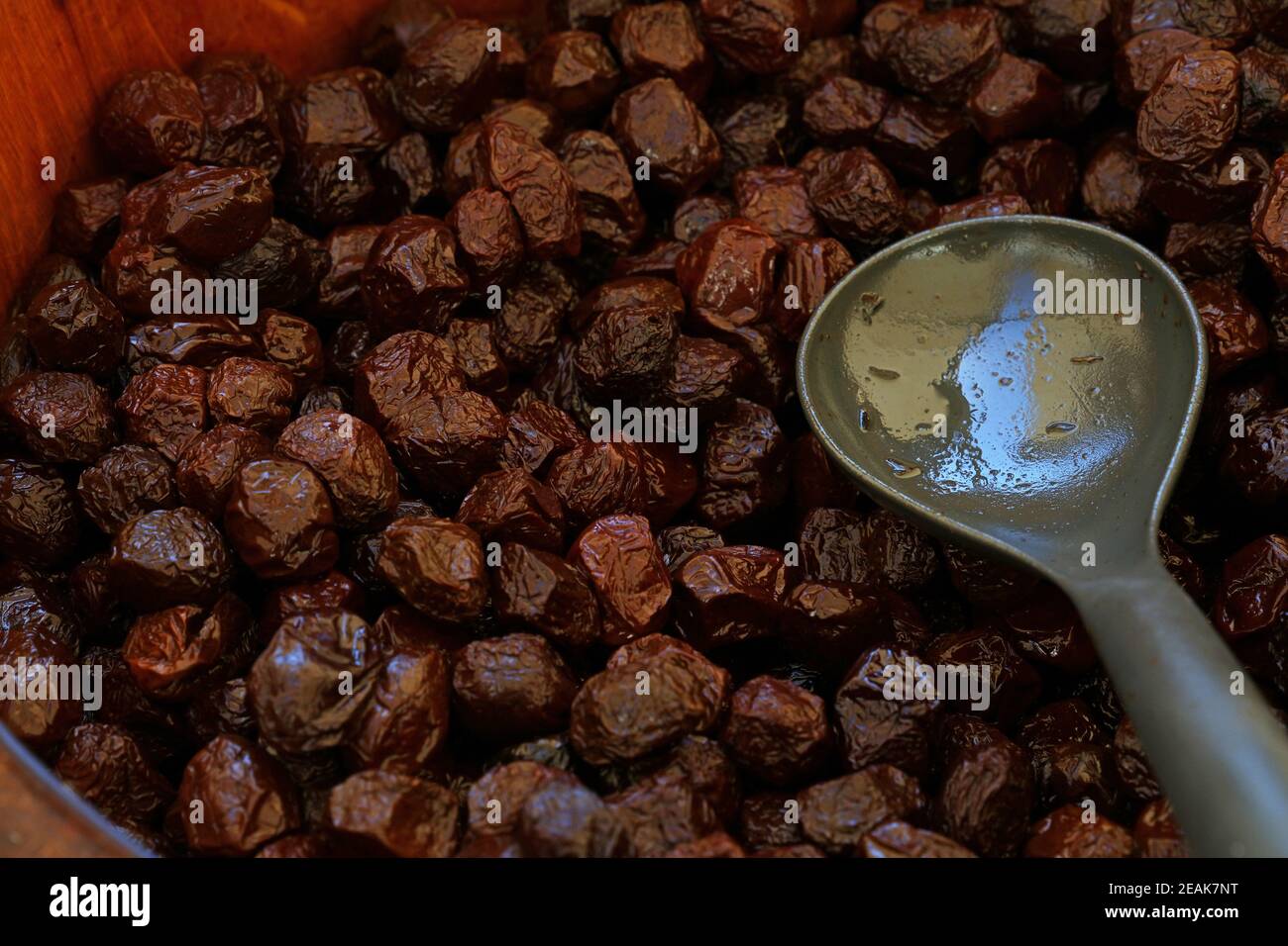 Pickled cured black olives and scoop in a barrel Stock Photo - Alamy