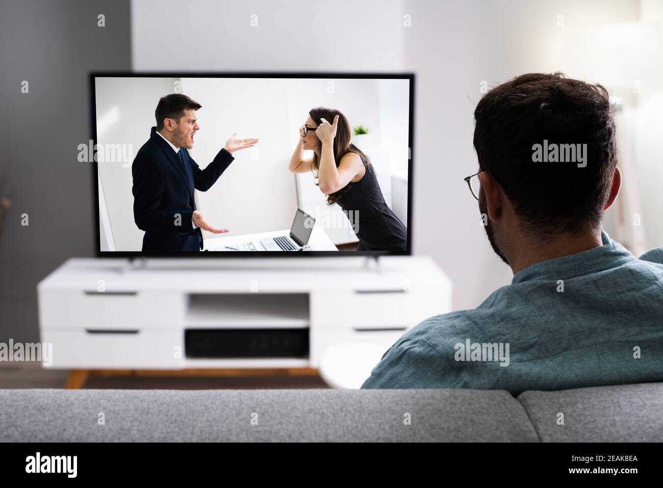 Angry man watching tv on hi-res stock photography and images - Alamy