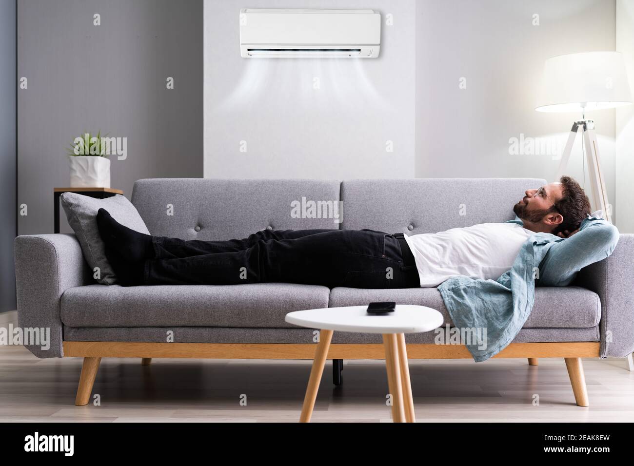 Happy Man Relaxing And Enjoying Cool Air Conditioner Stock Photo - Alamy