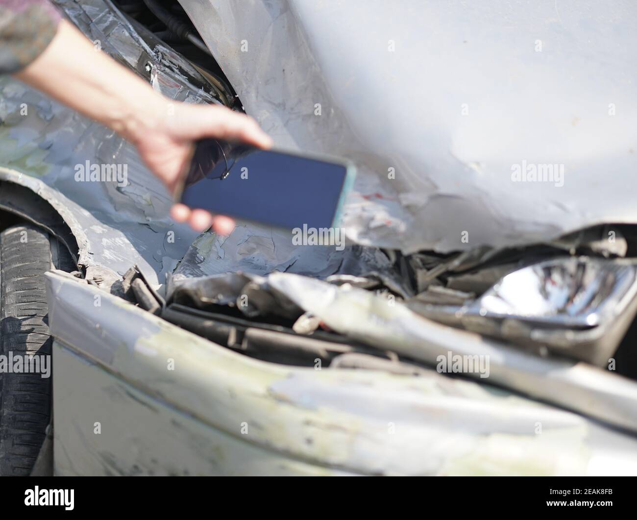 hand take photo of crashed damaged broken car. automobile crash ...