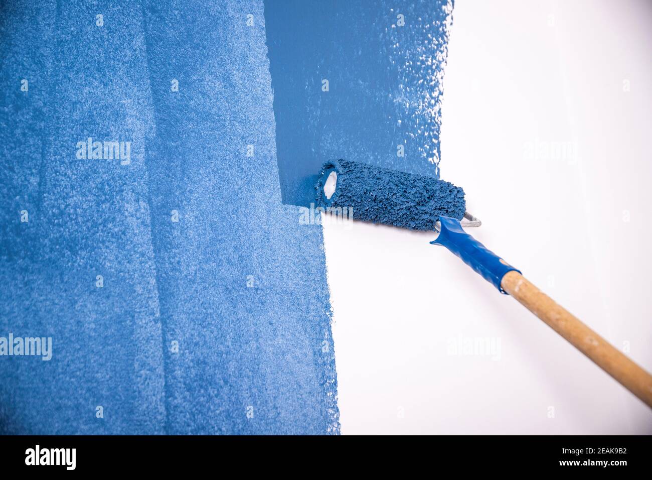 Paint roller to paint white wall room house home painter hi-res stock ...