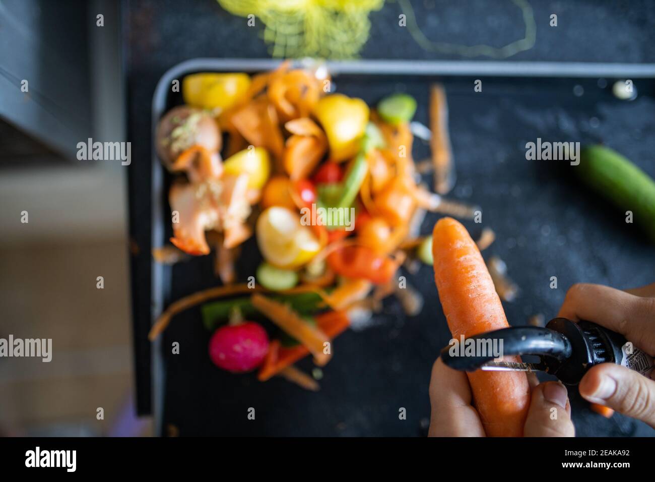 Female hands peeling a carrot on top of organic trash Stock Photo - Alamy