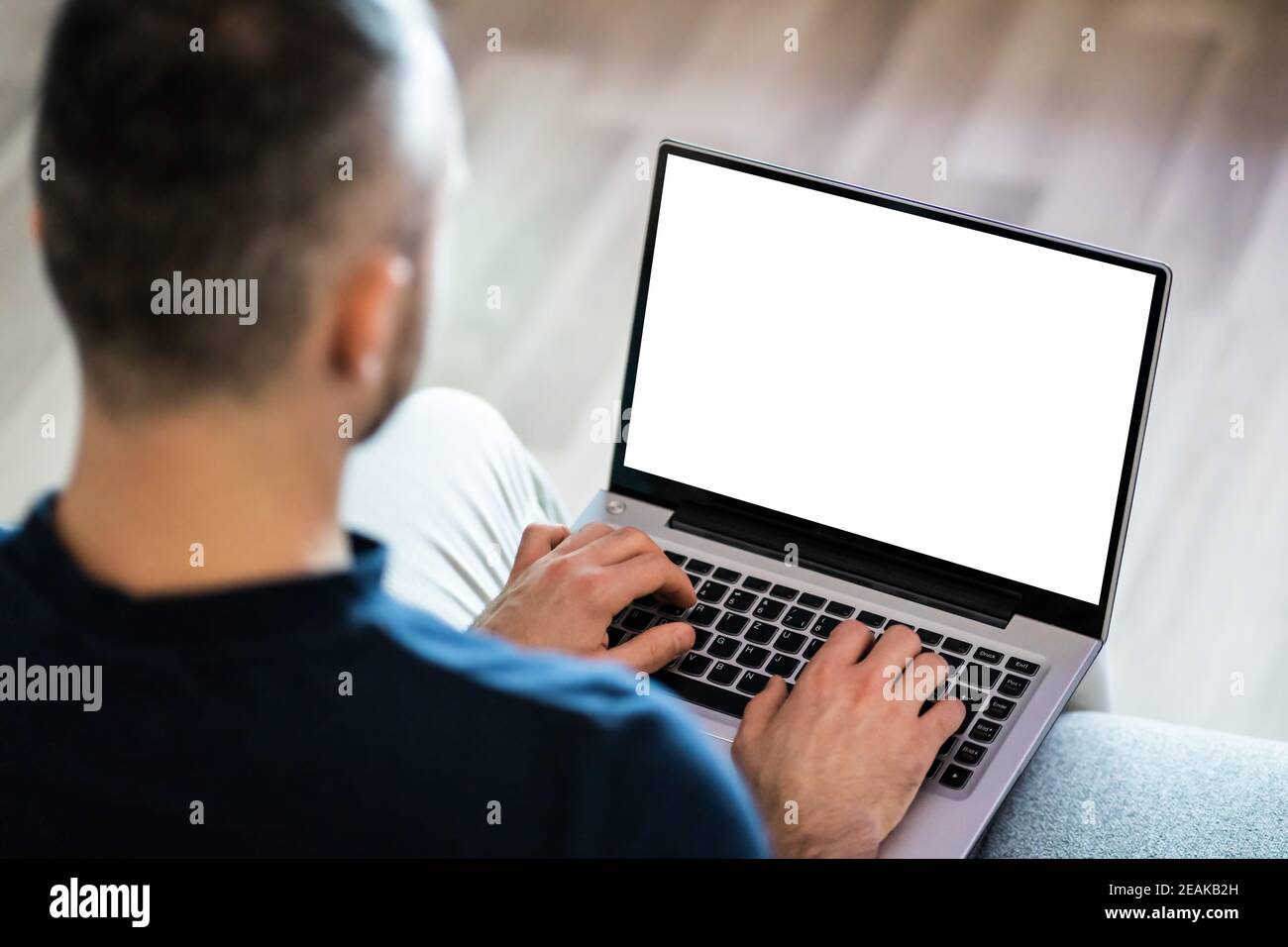 Guy Sitting On Sofa Using Laptop Stock Photo - Alamy