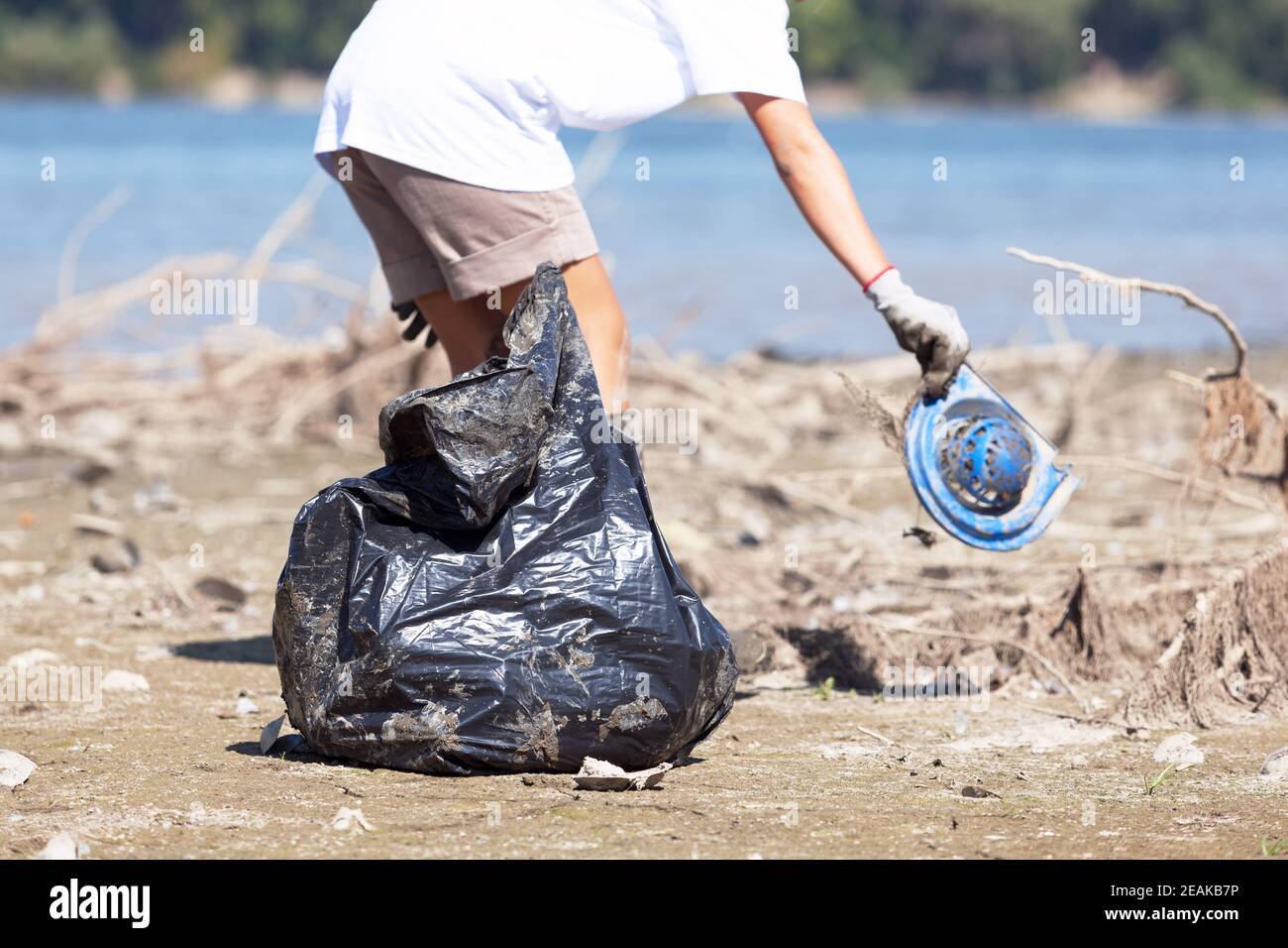 Collecting plastic waste at river or lake bank Stock Photo - Alamy