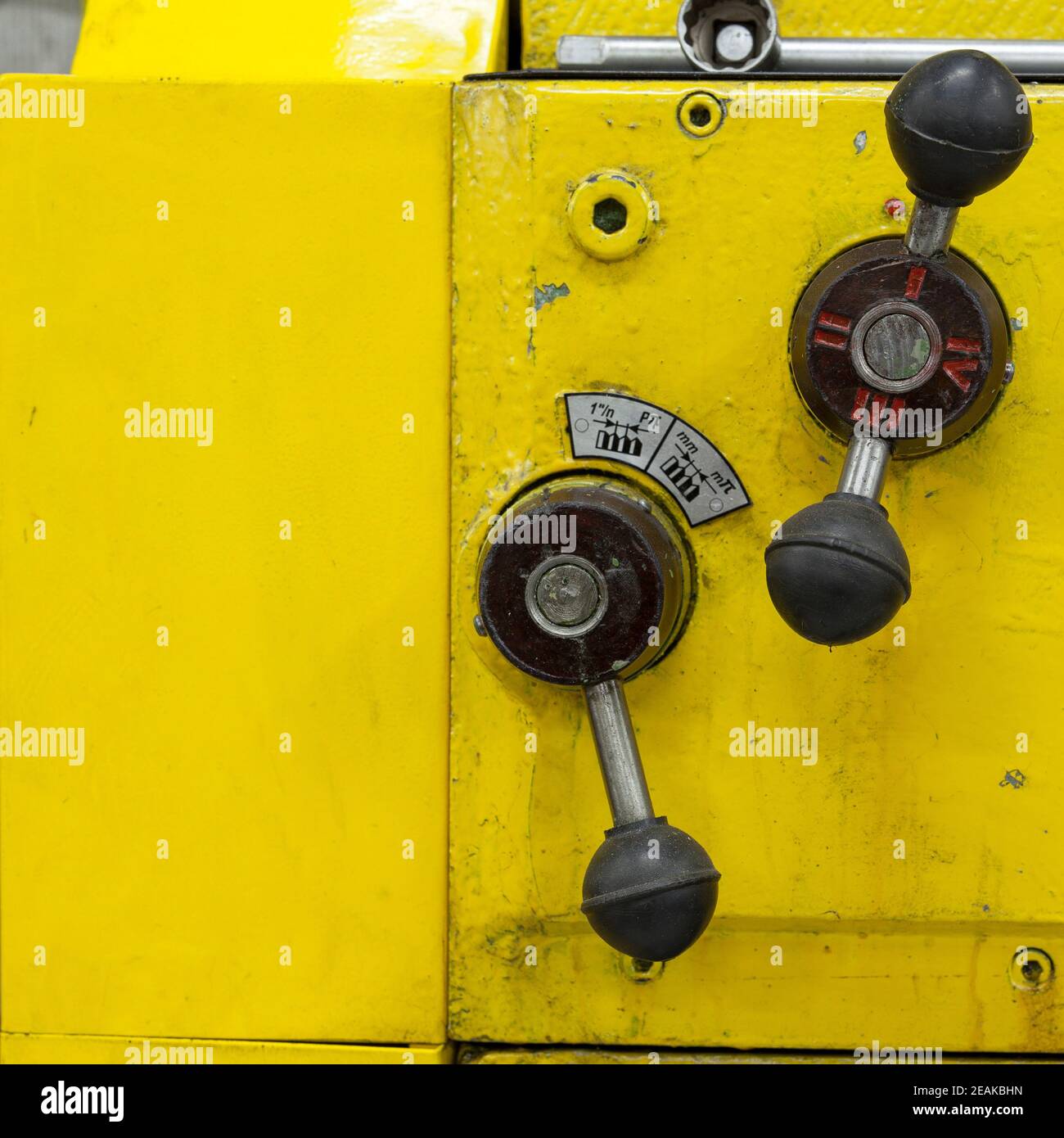 Old yellow lathe machine with a lot of handles Stock Photo - Alamy