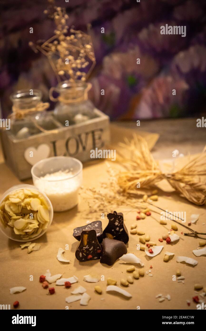 Handmade candies with fresh and dried fruits on light paper background ...