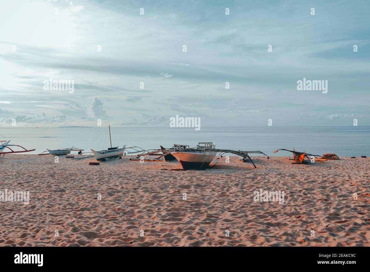 Traditional Filipino boat on a white beach in the sea Stock Photo - Alamy