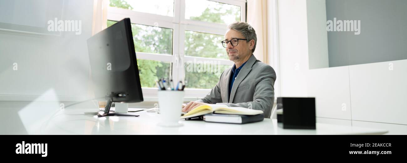 Happy Professional Man Employee Using Computer Stock Photo - Alamy