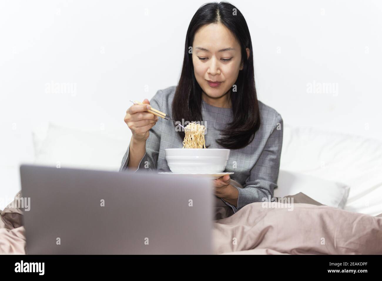 Asian businesswoman eating at computer hi-res stock photography and ...