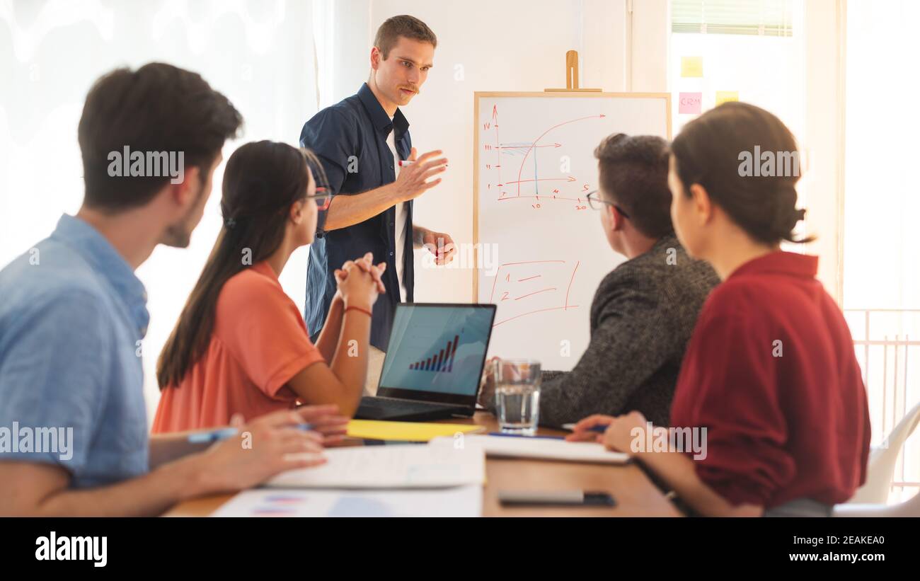 Male colleague briefing to his other friend Stock Photo - Alamy