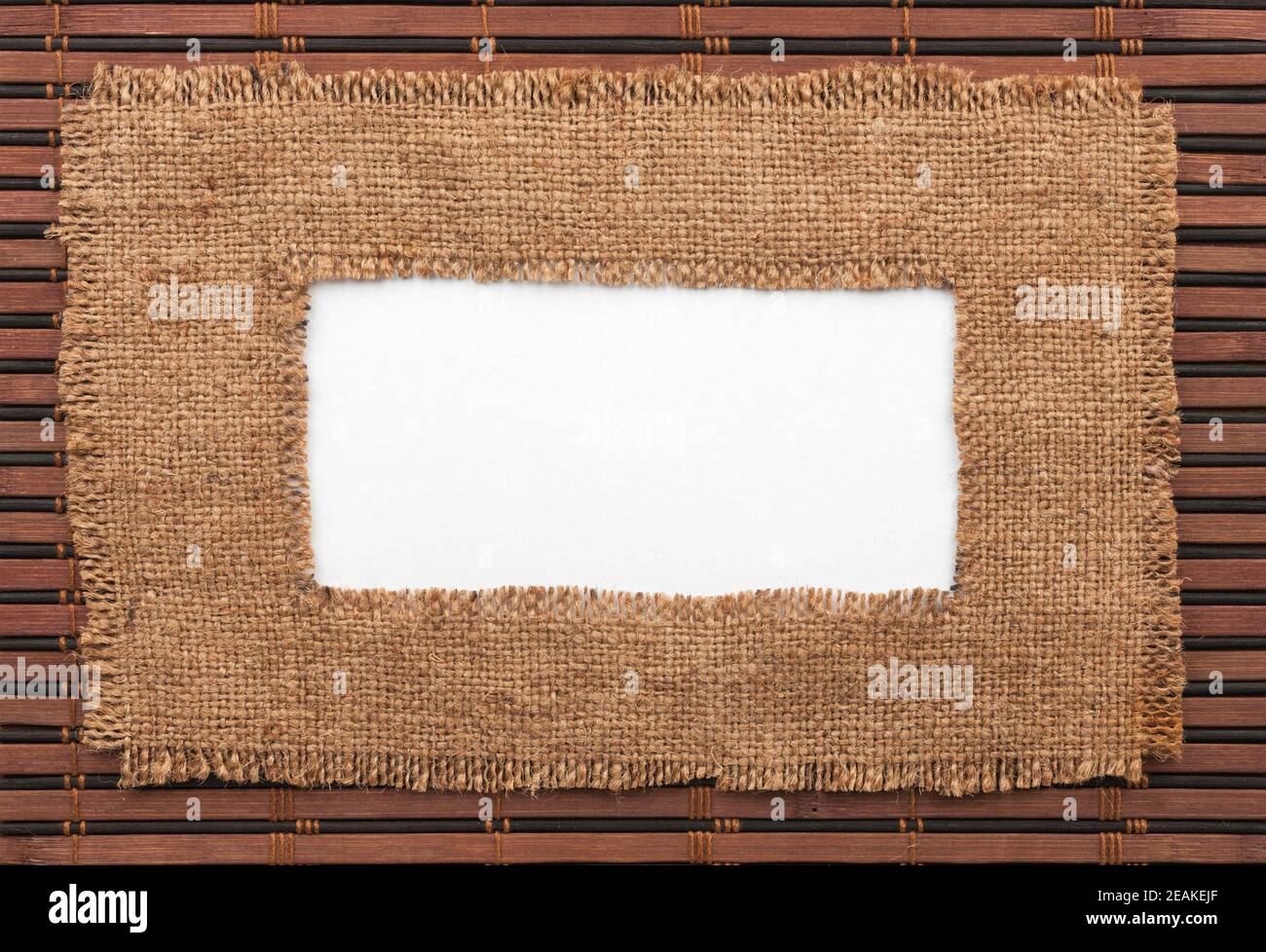 Frame made of burlap with white background lying on a bamboo mat Stock ...