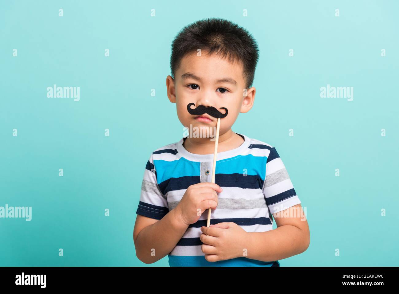 Funny happy hipster kid holding black mustache Stock Photo - Alamy